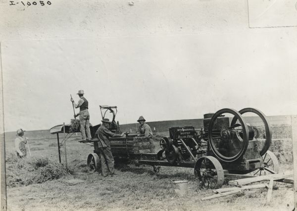 Men with International Motor Baling Press | Photograph | Wisconsin ...