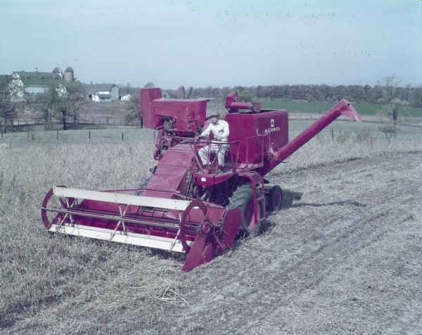 Man using McCormick combine in field | Photograph | Wisconsin ...