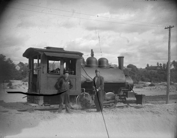 Two Men and Small Locomotive | Photograph | Wisconsin Historical Society