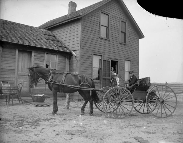 Man in Wagon | Photograph | Wisconsin Historical Society