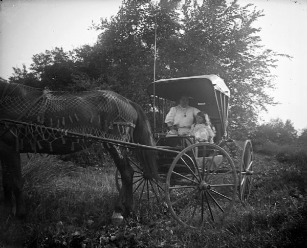 Woman and Child in Carriage | Photograph | Wisconsin Historical Society