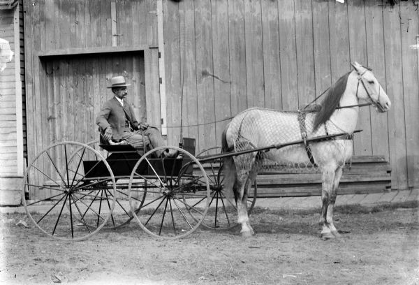 Man in Wagon | Photograph | Wisconsin Historical Society