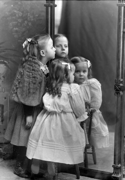 Two Girls Reflected in Mirror | Photograph | Wisconsin Historical Society