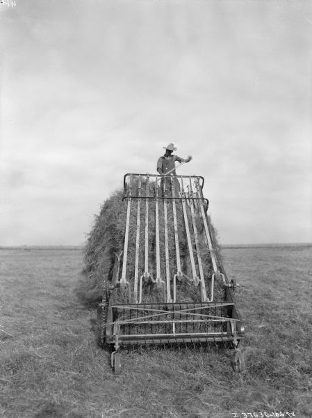Man Operating IH Hay Loader in a Field | Photograph | Wisconsin ...