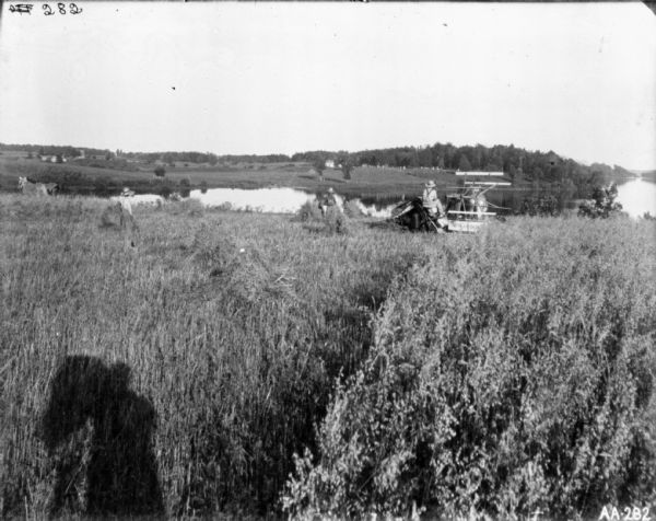 Man Using Binder in Field near Lake | Photograph | Wisconsin Historical ...