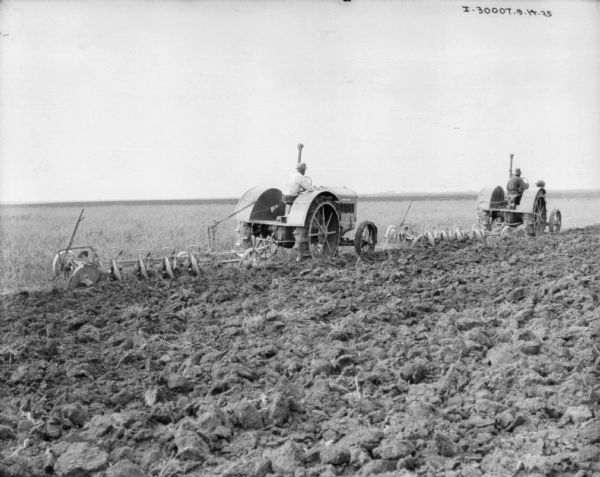 Men Driving Tractors in Field | Photograph | Wisconsin Historical Society