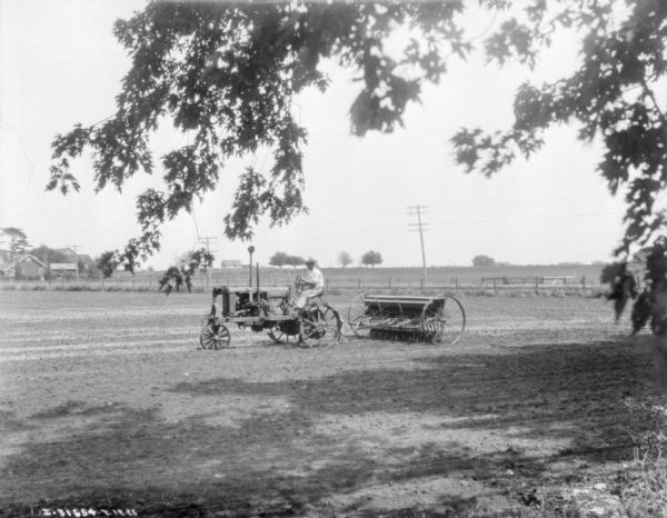 Man Using Farmall Tractor for Seeding Field | Photograph | Wisconsin ...