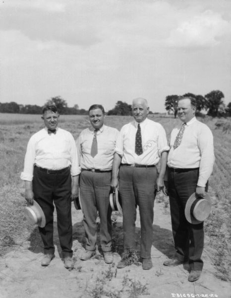Four Men Posing in Field | Photograph | Wisconsin Historical Society