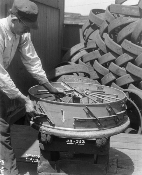Man Assembling Wheel | Photograph | Wisconsin Historical Society