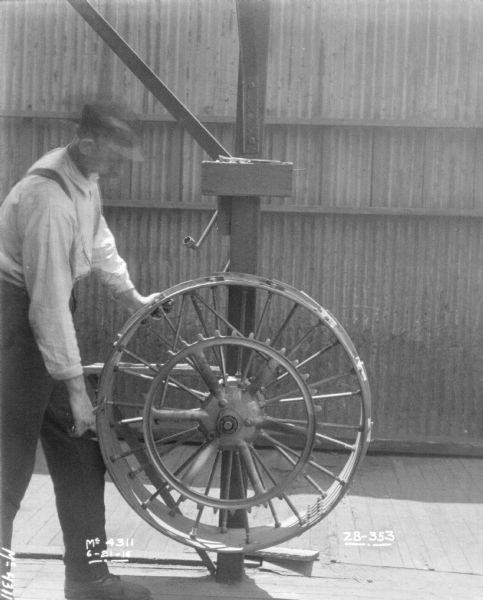 Man Assembling Wheel | Photograph | Wisconsin Historical Society