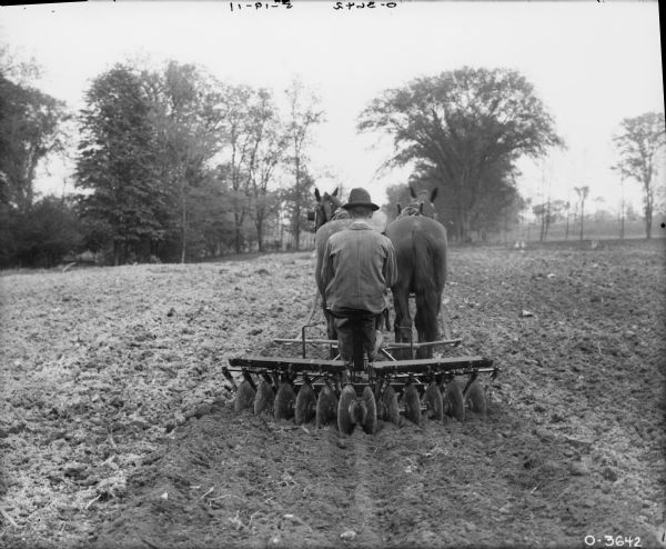 Man on Horse-Drawn Disk Harrow | Photograph | Wisconsin Historical Society