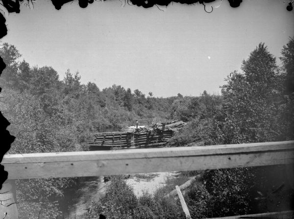 Man on Log Dam | Photograph | Wisconsin Historical Society