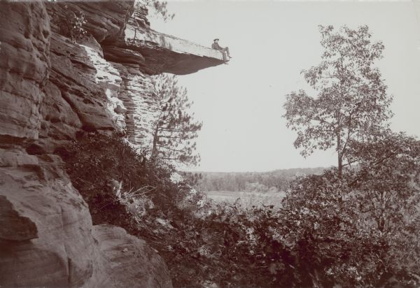Man Sitting on Visor Ledge | Photograph | Wisconsin Historical Society